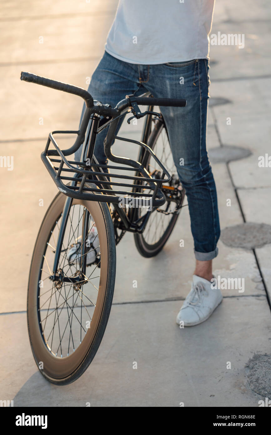 Close-up of man with commuter fixie bike on concrete slabs Stock Photo ...