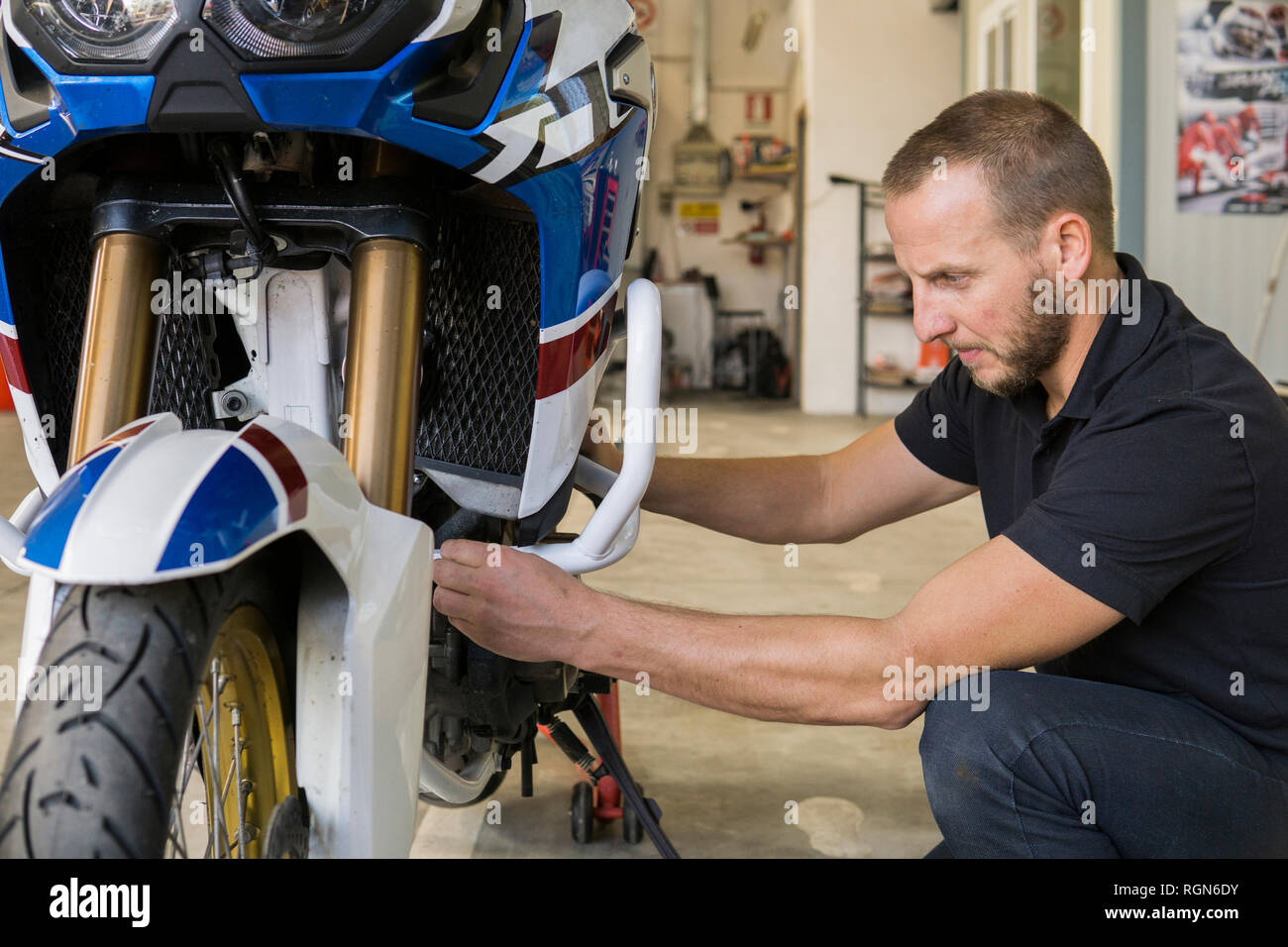 Repairman working on motorbike hi-res stock photography and images - Alamy