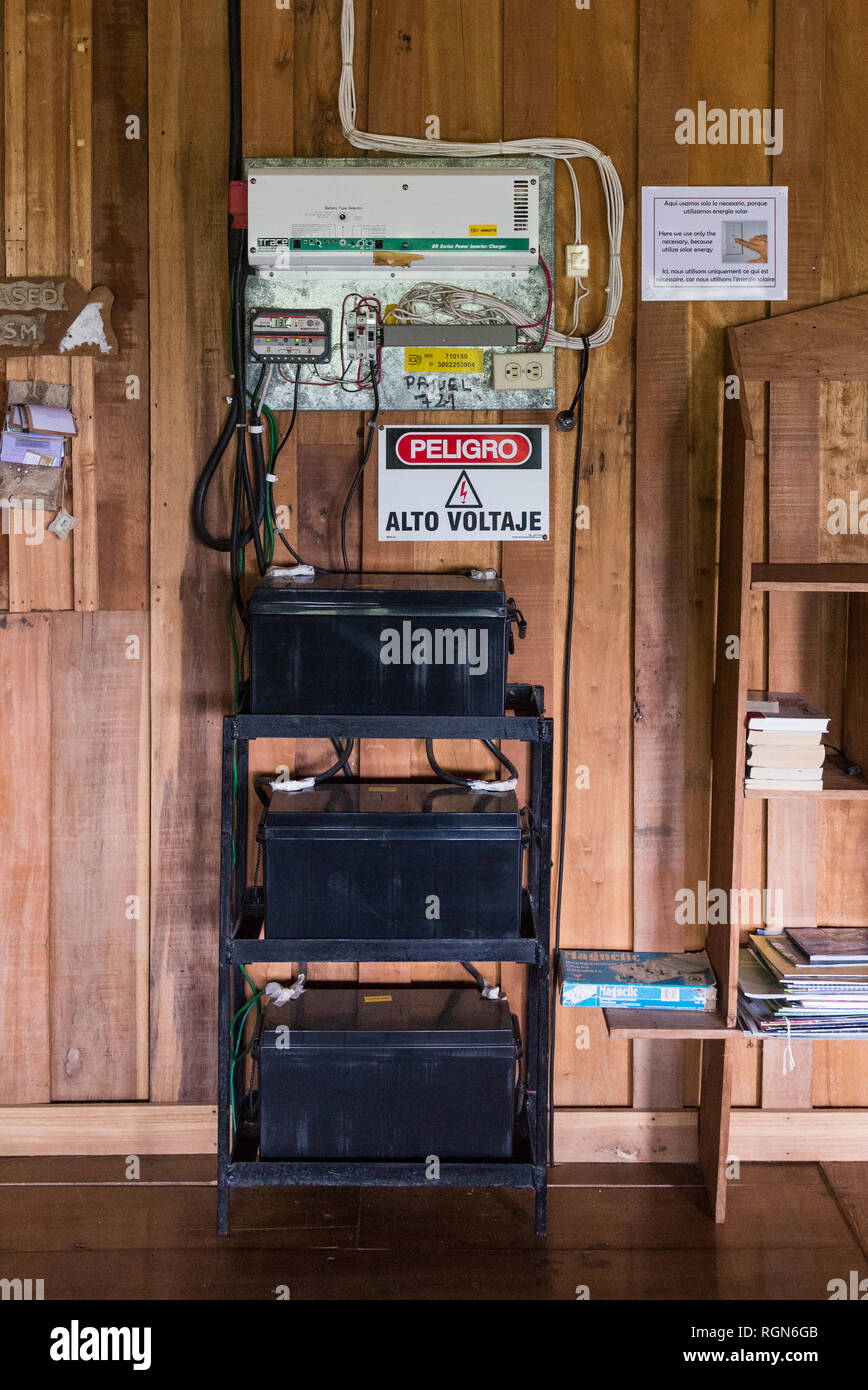 A battery array charged by solar panels supplies power in rural Costa ...