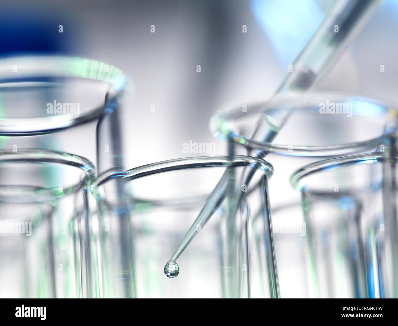 Scientist pipetting a sample into a test tube during a experiment in ...