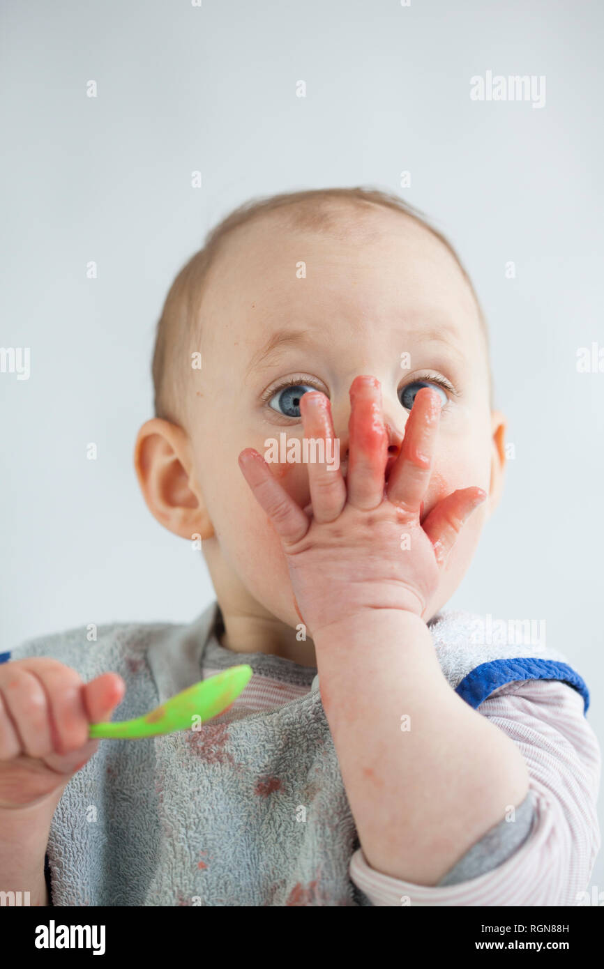Portrait of baby girl eating mush Stock Photo - Alamy