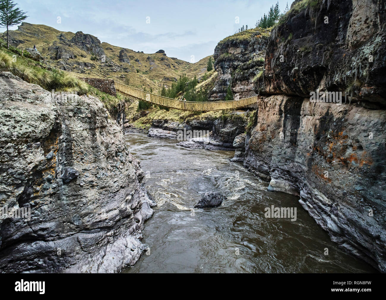 Peru, Quehue, woman crossing rope bridge Stock Photo - Alamy