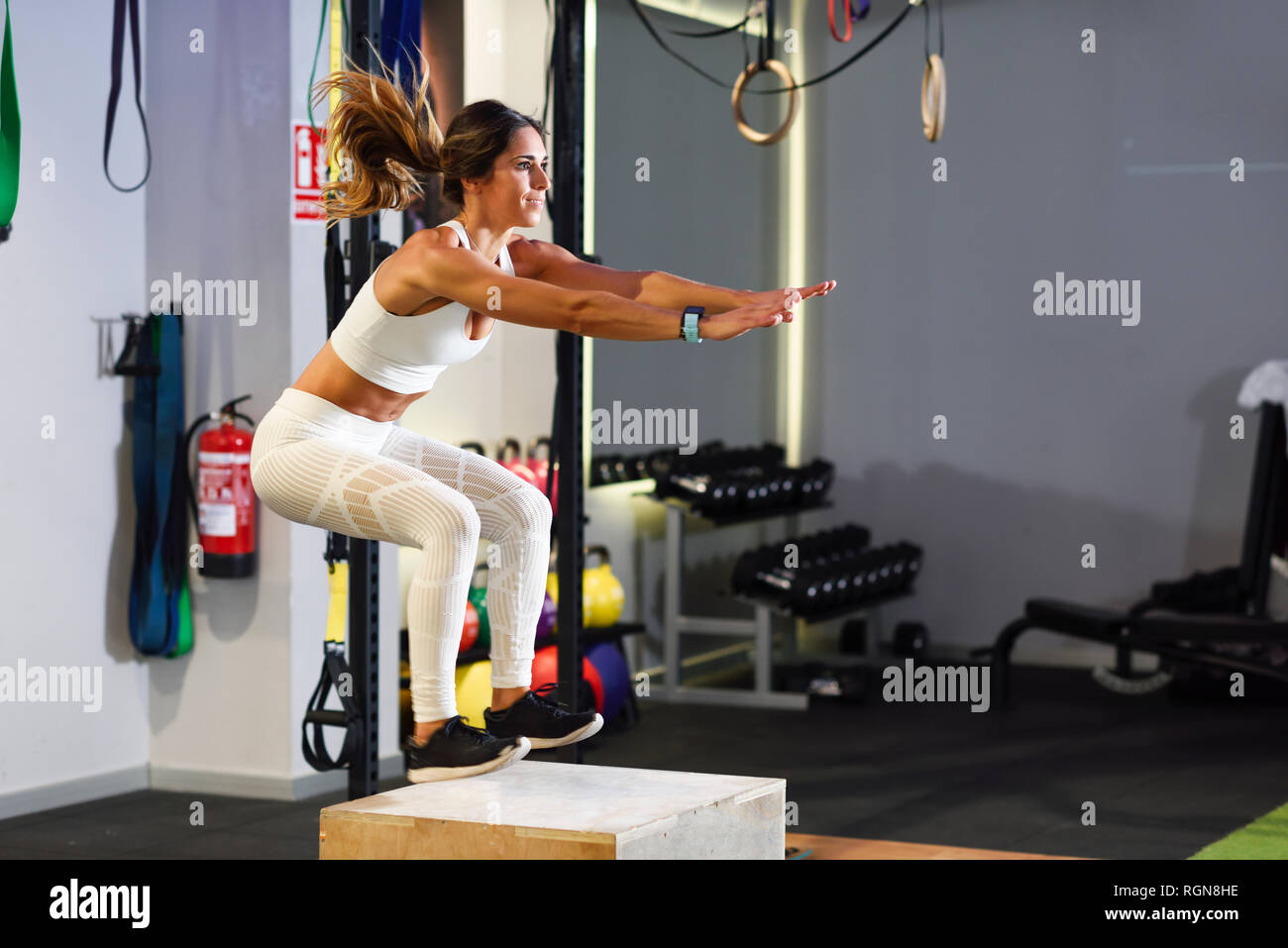 Man doing box jumps in a gym Stock Photo - Alamy