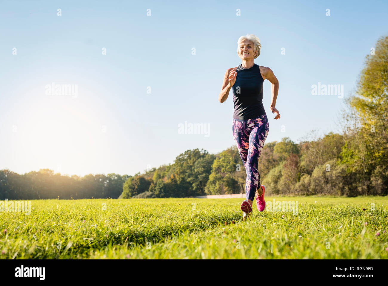 Woman running senior hi-res stock photography and images - Alamy