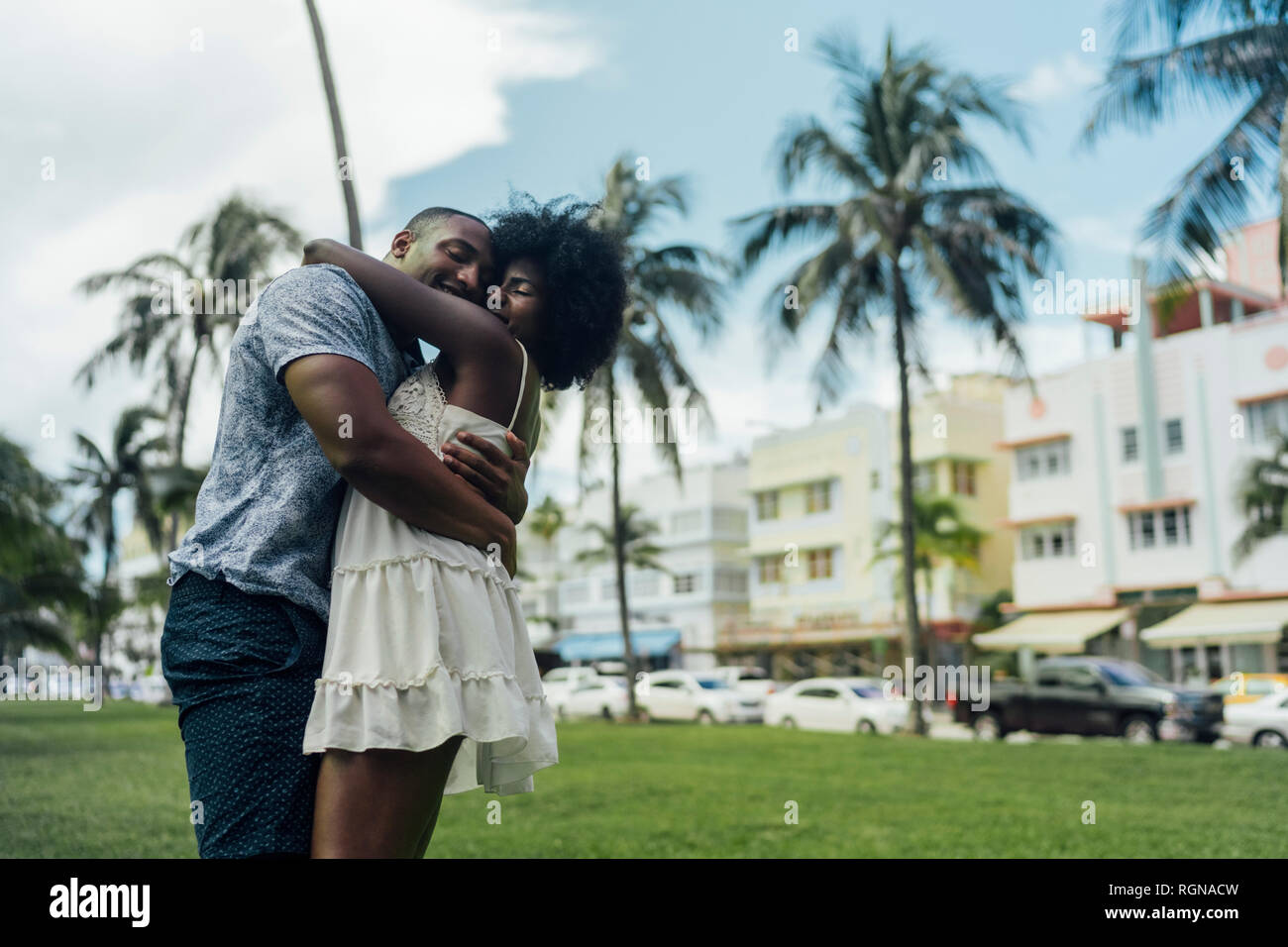 USA, Florida, Miami Beach, happy young couple hugging in a park in ...