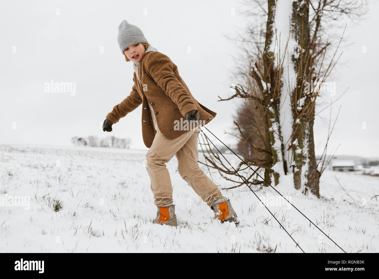 Boy pulling sledge hi-res stock photography and images - Alamy