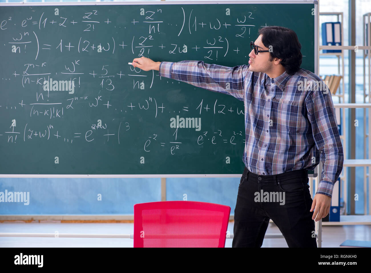 Young funny math teacher in front of chalkboard Stock Photo - Alamy
