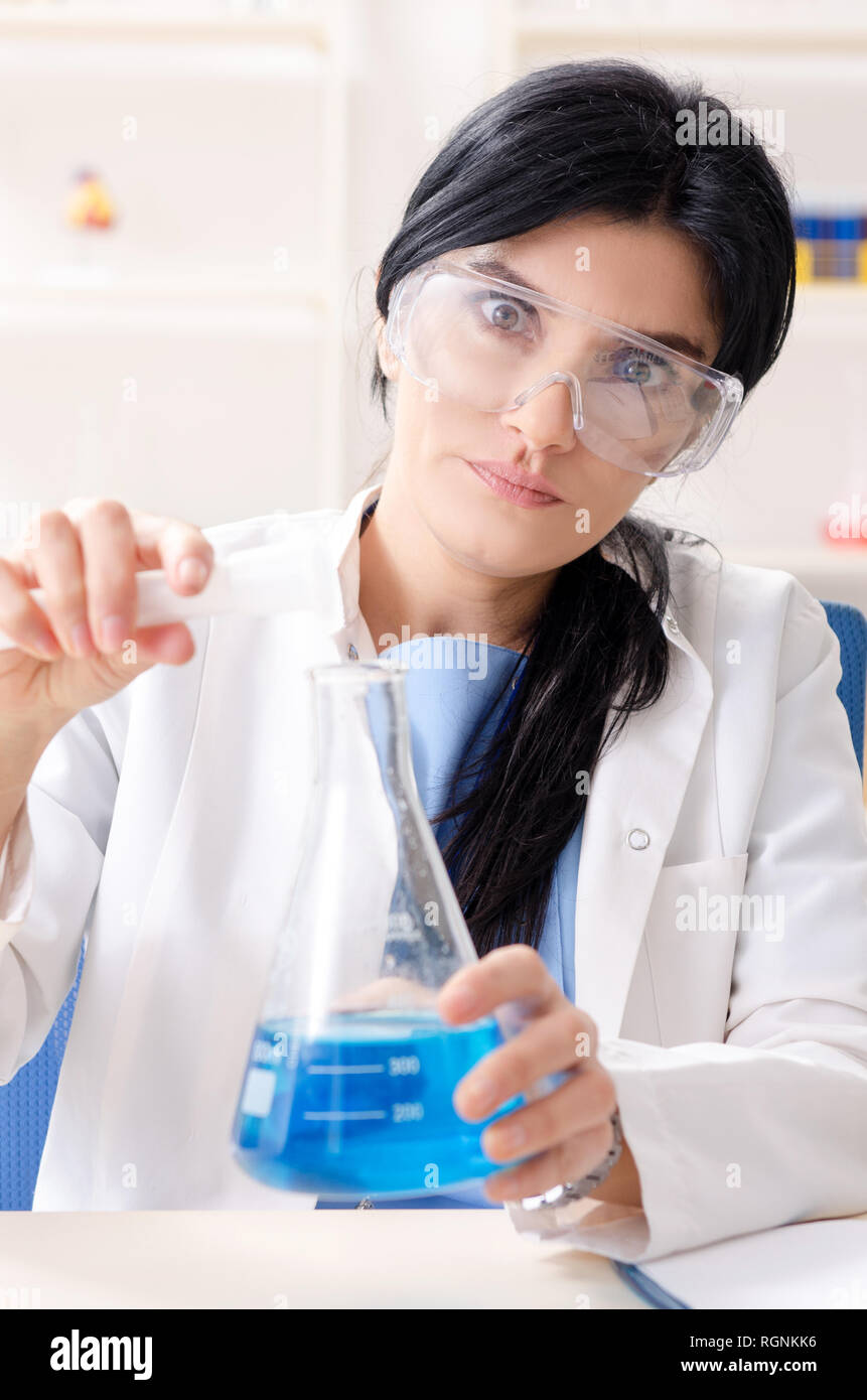 Female scientist mixing chemical solution hi-res stock photography and ...