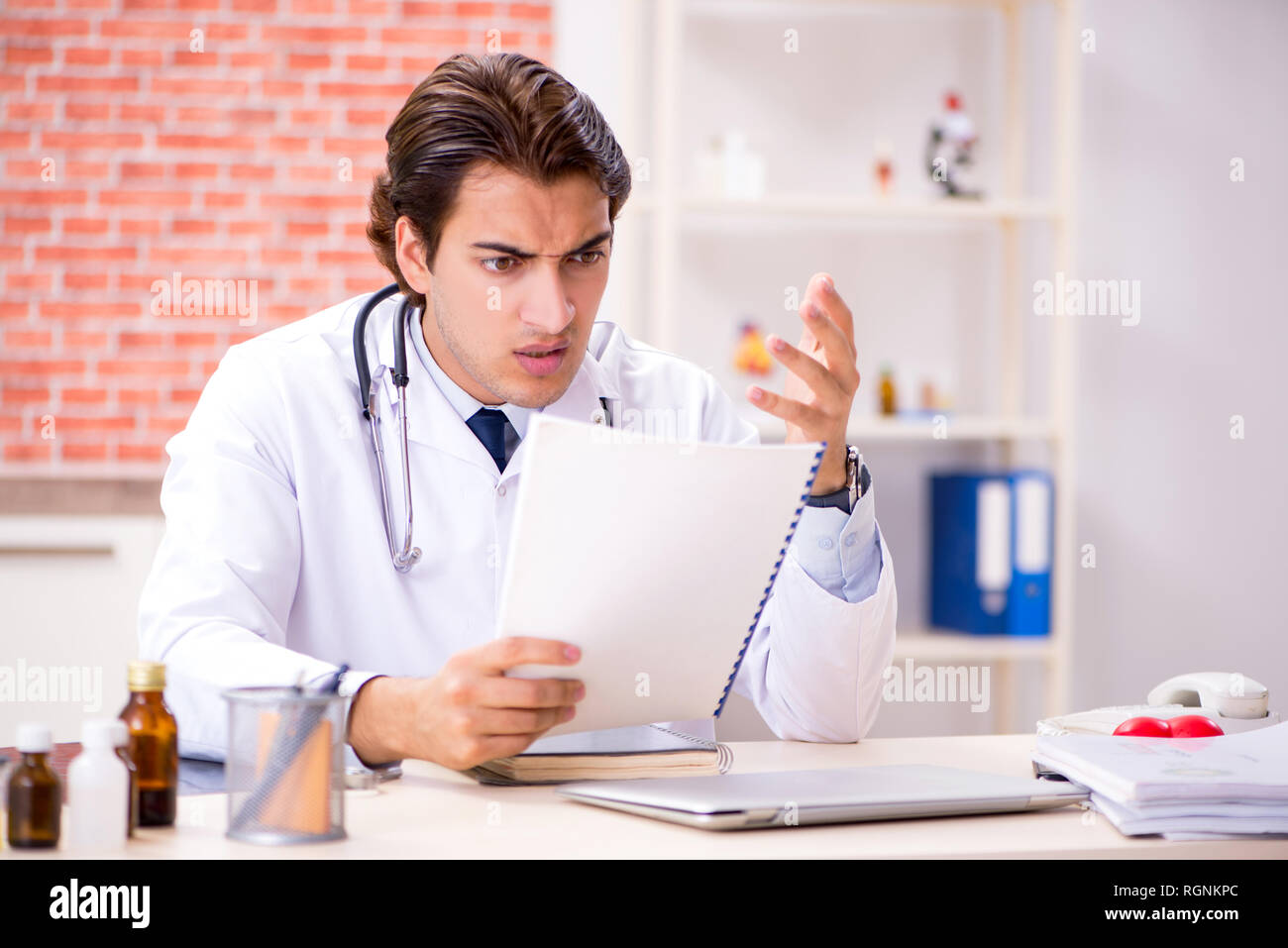 Young doctor working in hospital Stock Photo - Alamy