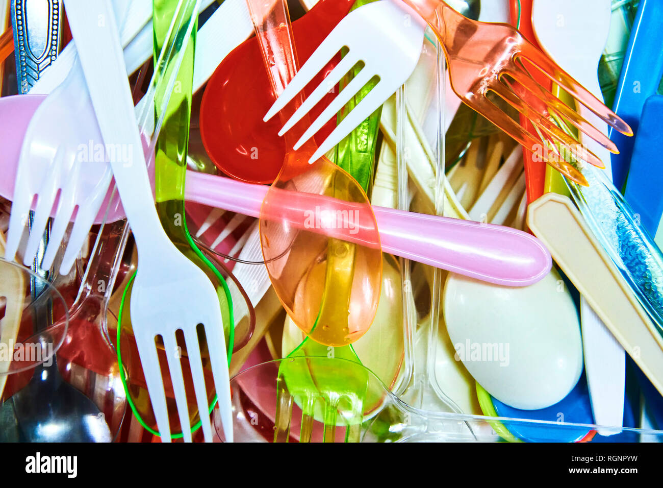 Closeup of many plastic fork and spoons in all different shapes and ...