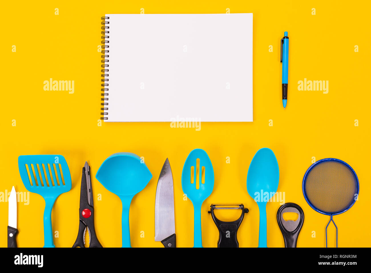 Kitchen utensils and clean sheet of paper isolated on yellow background ...
