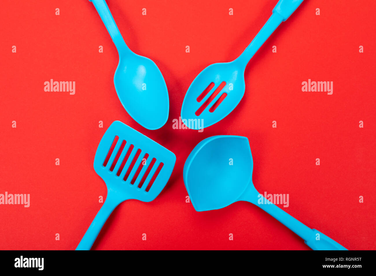 top view of blue kitchen utensils isolated on red background Stock ...