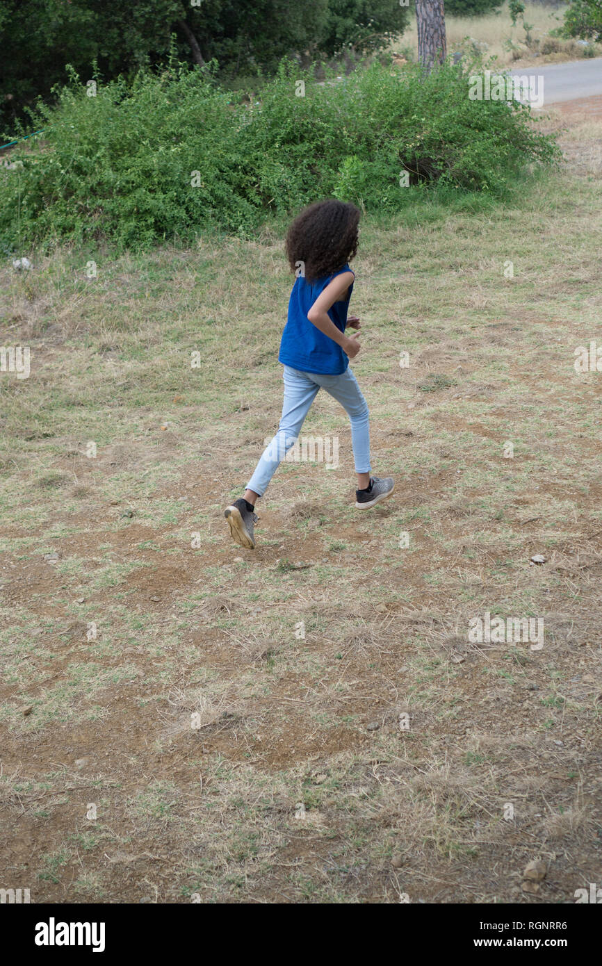 Girl running away Stock Photo - Alamy