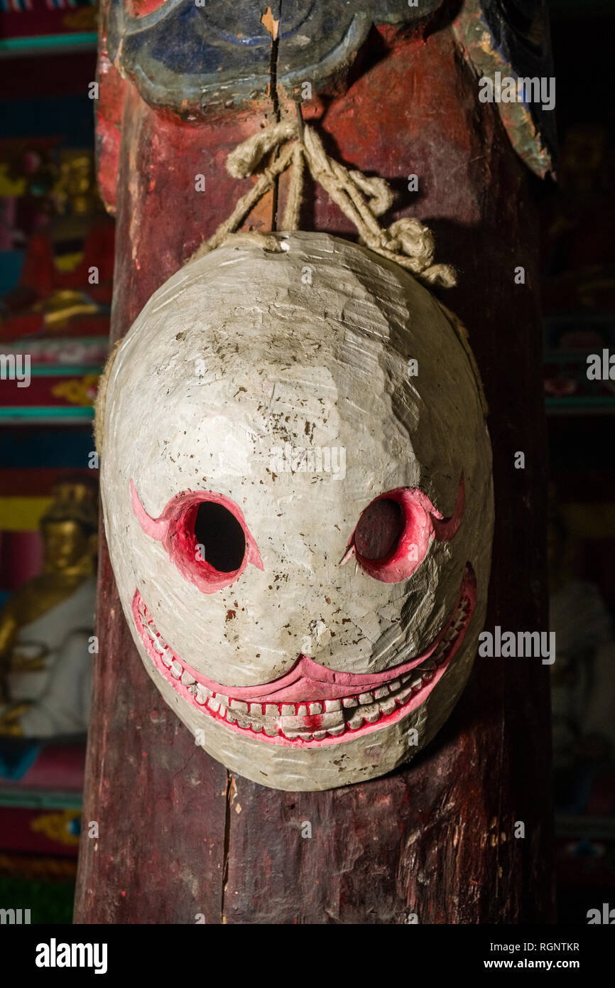 A colorfully painted buddhist mask for ritual dances inside Braga Gompa ...