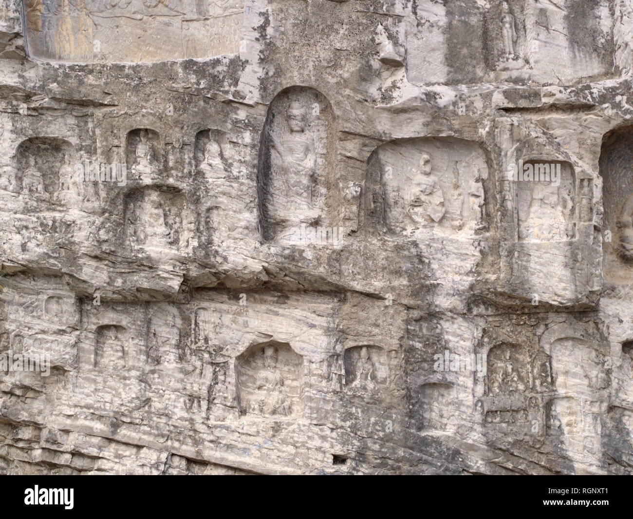 Luoyang Longmen grottoes. Broken Buddha and the stone caves and ...