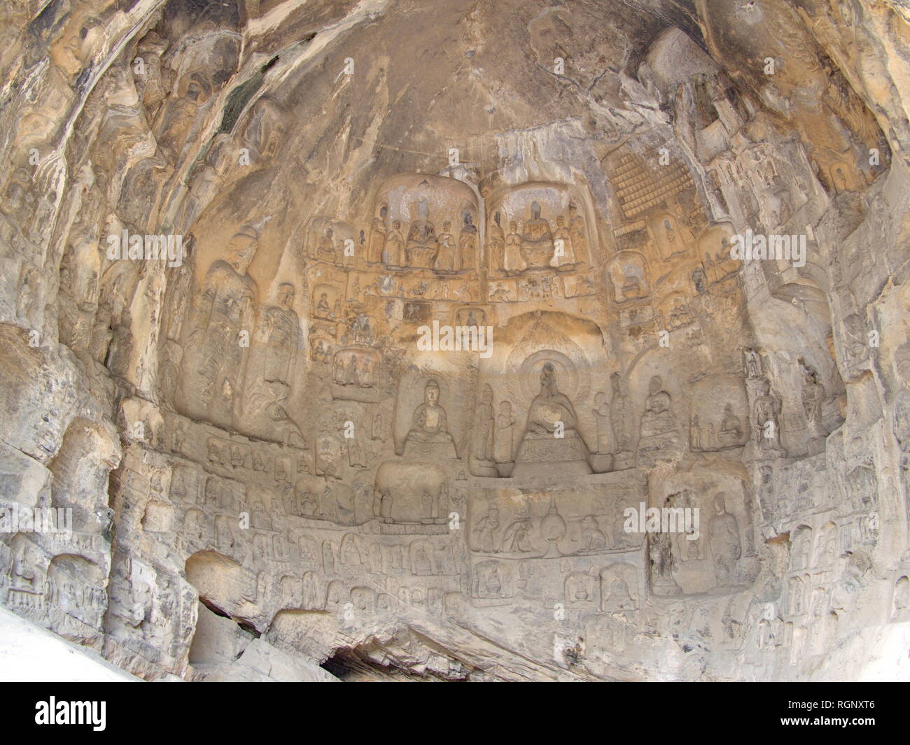 Luoyang Longmen grottoes. Broken Buddha and the stone caves and ...