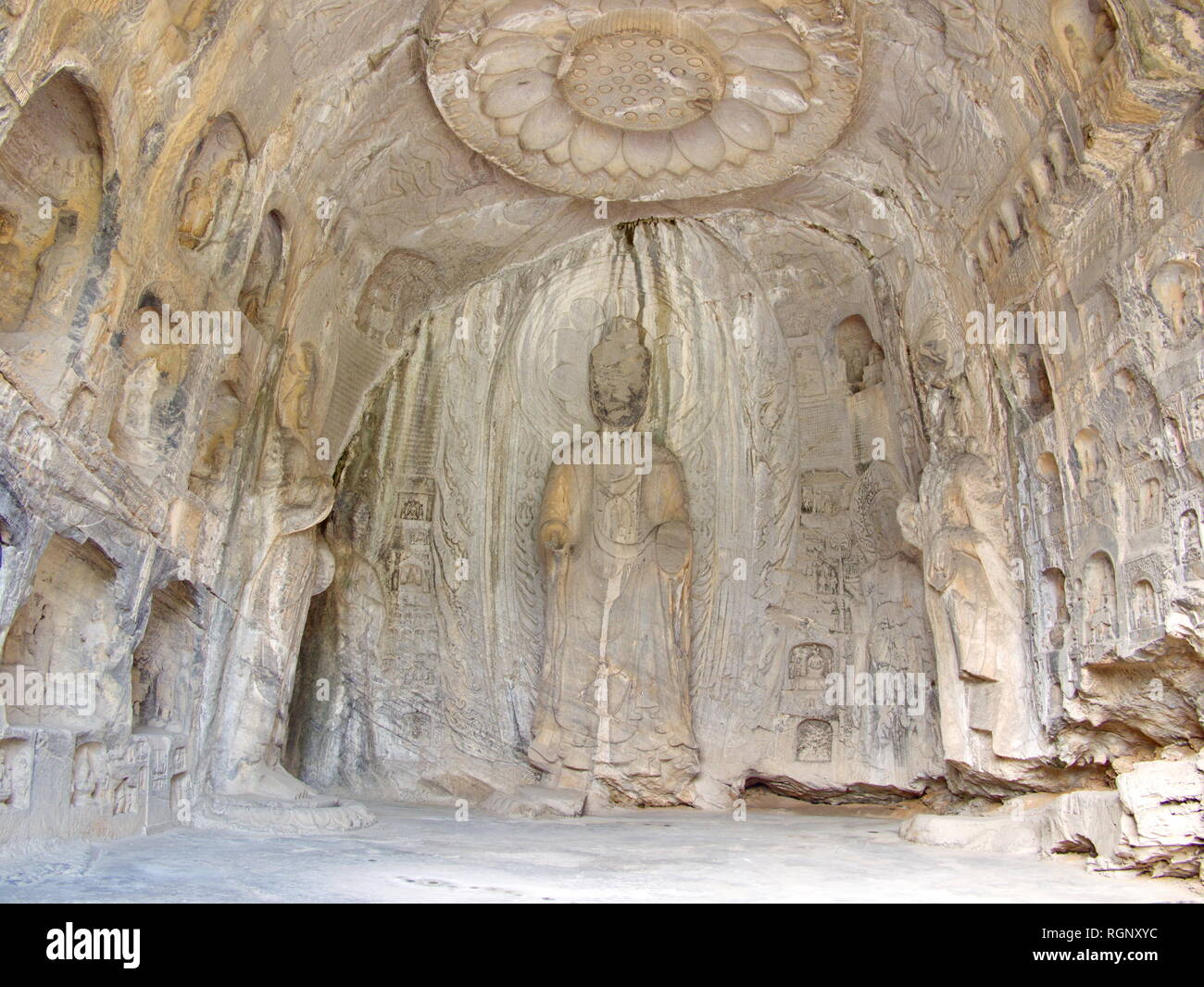 Luoyang Longmen grottoes. Broken Buddha and the stone caves and ...