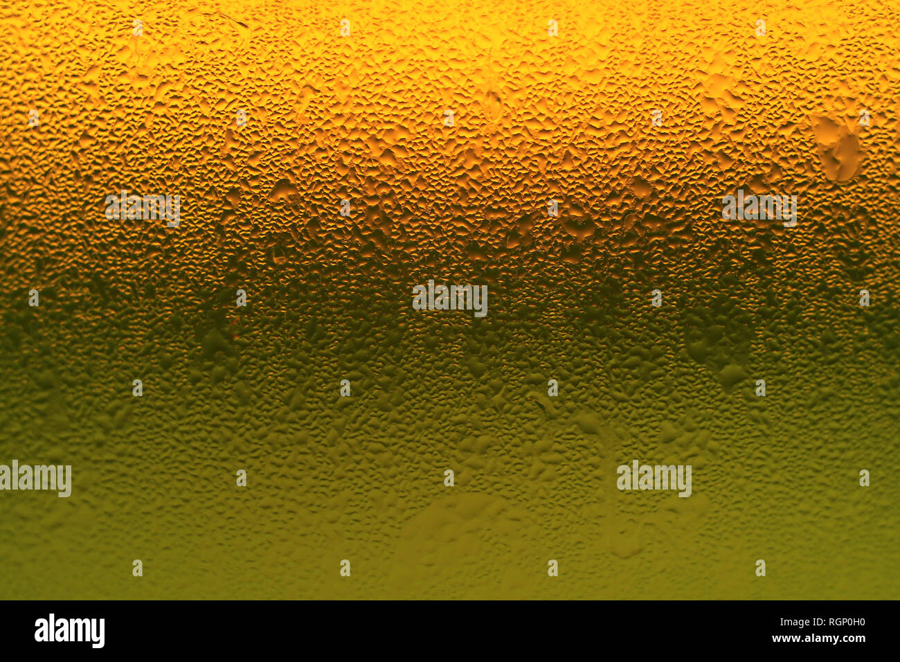 Artistic condensation on vibrant orange and green color glass bottle ...