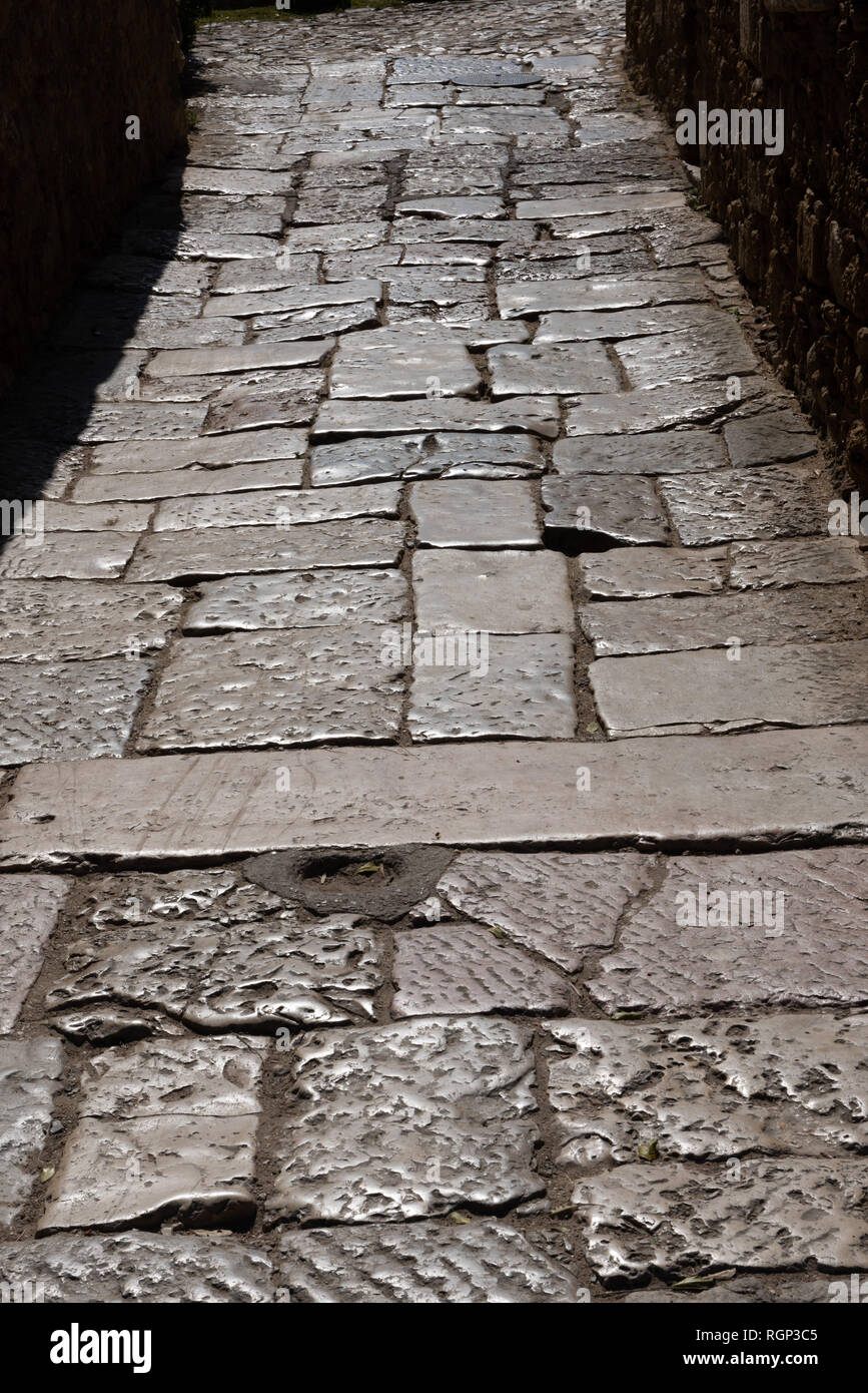 Old irregular paved footpath with made of big beige square blocks Stock ...