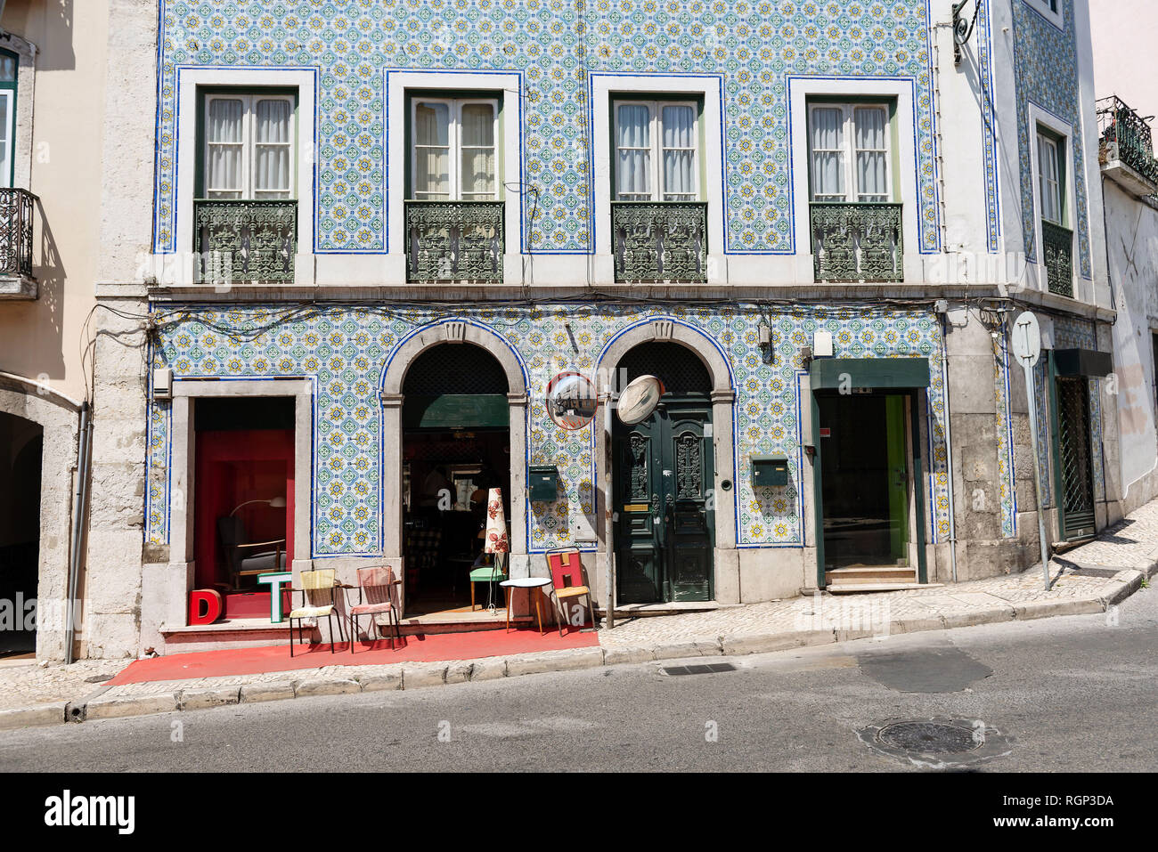 Nice tiled facade in Lisbon with chairs in front Stock Photo - Alamy