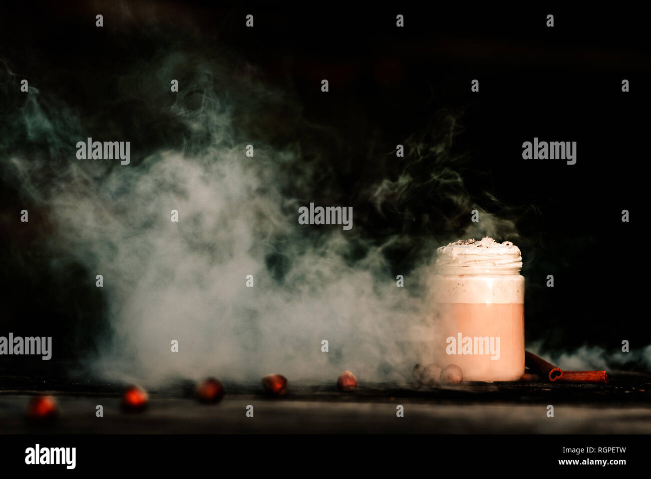 Thin white fume spreading over tabletop with jar of fresh coffee and ...