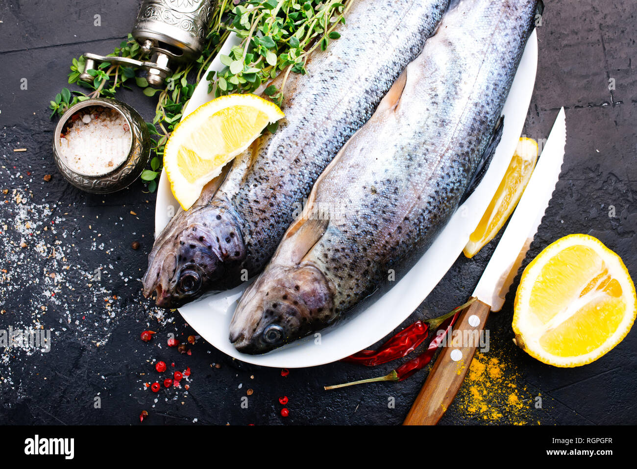 raw fish with salt and aroma pepper spice Stock Photo - Alamy