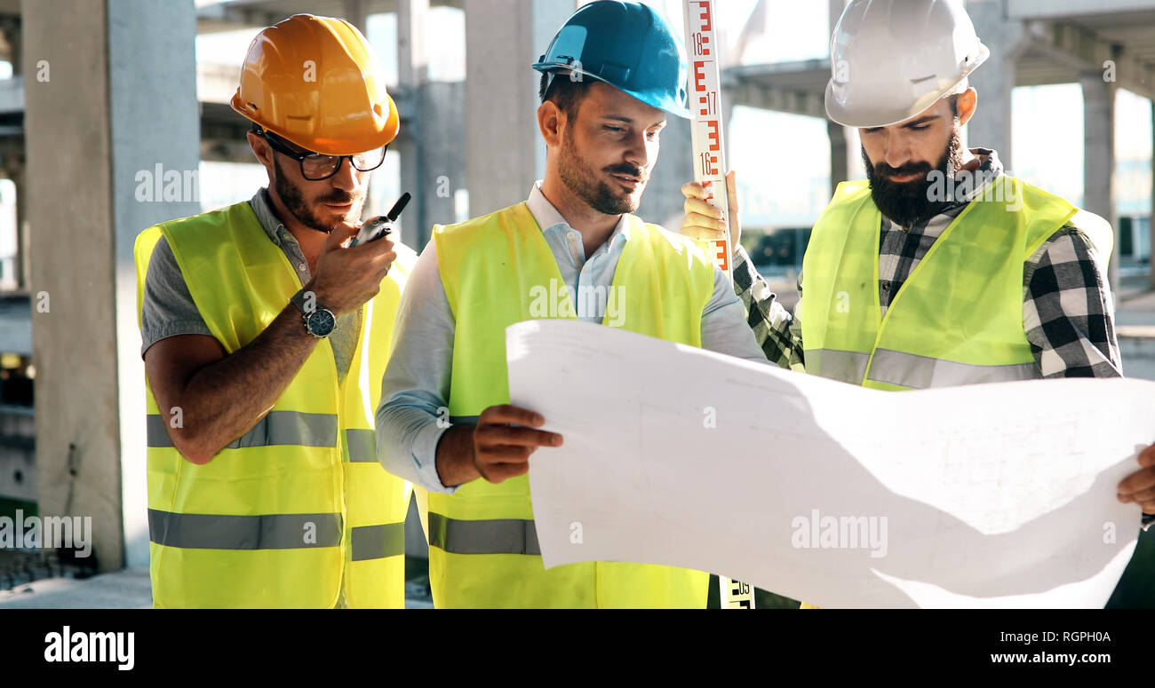 Portrait of construction engineers working on building site Stock Photo ...