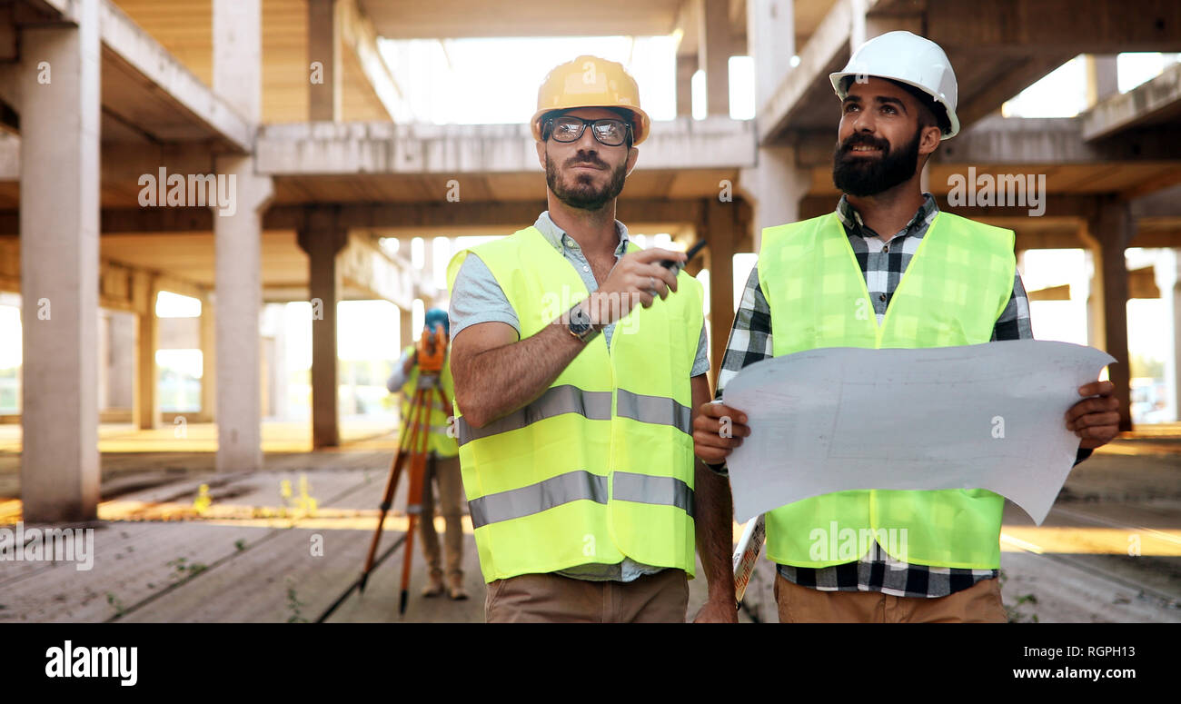Portrait of construction engineers working on building site Stock Photo ...