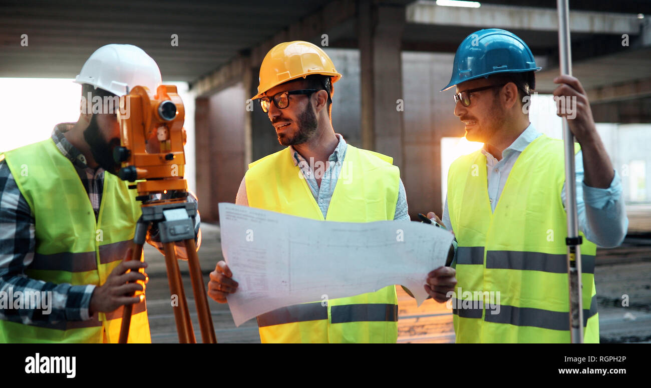 Team of architects people in group on construciton site Stock Photo - Alamy