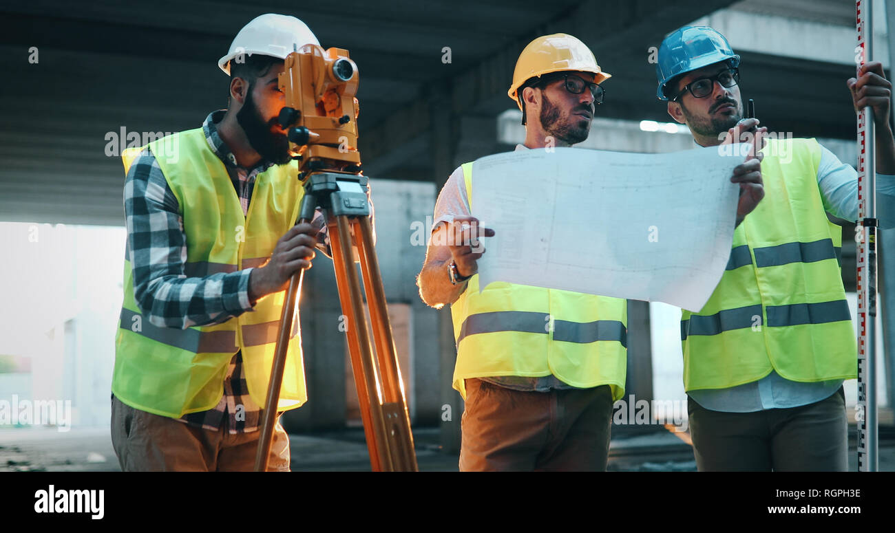 Construction engineers discussion with architects at construction site ...