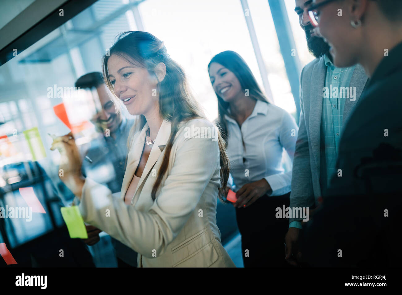 Picture of designers sticking notes in office Stock Photo - Alamy