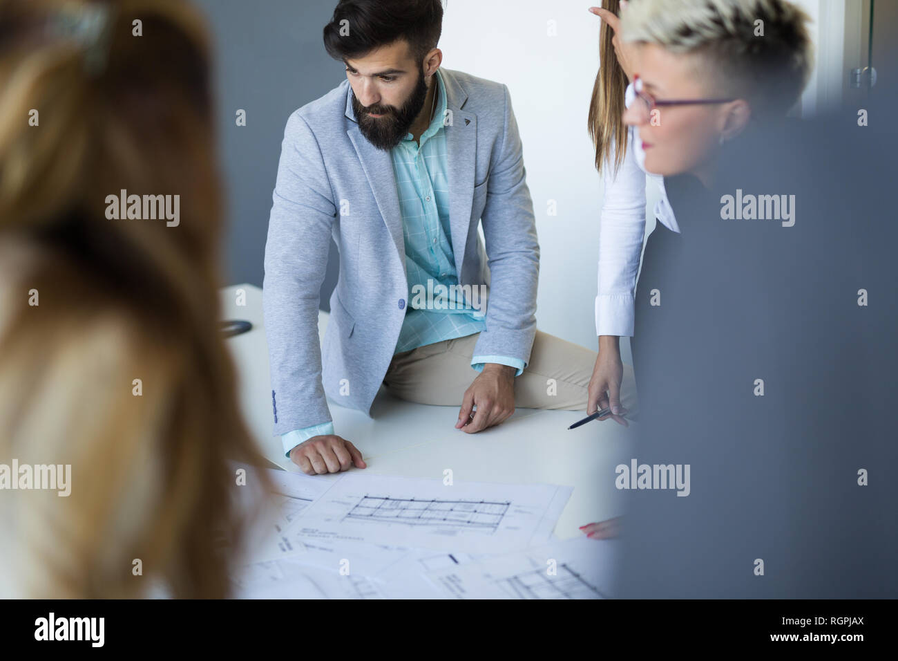 Portrait of architects having discussion in office Stock Photo - Alamy