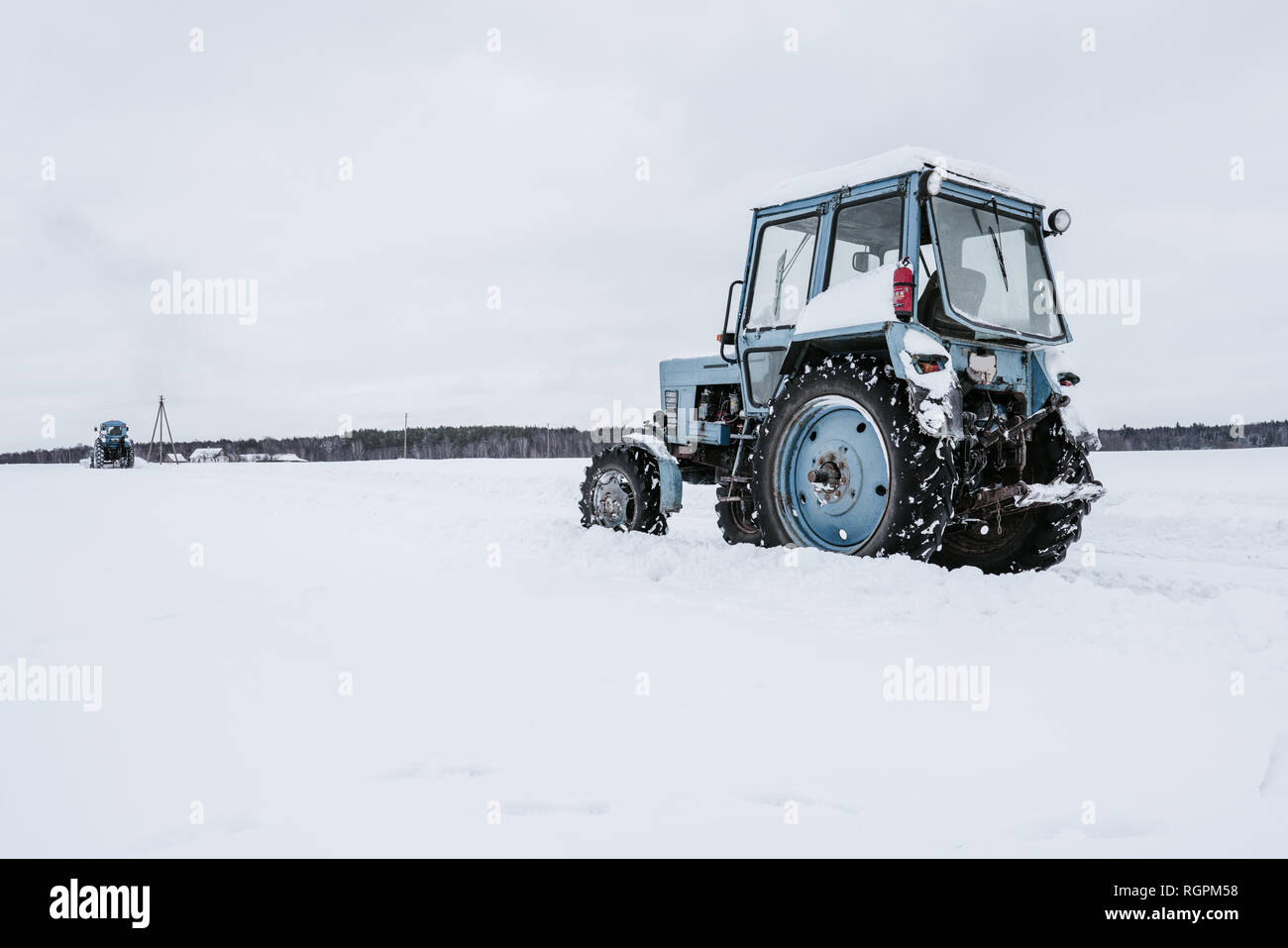 Tractors cleaning snow from field Stock Photo - Alamy