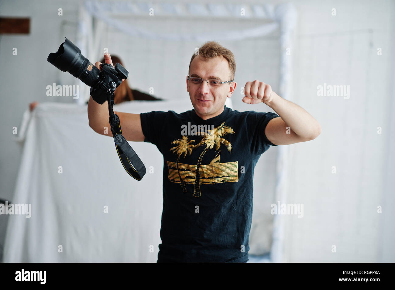Funny photogrpaher showing something with DSLR camera at hands Stock ...