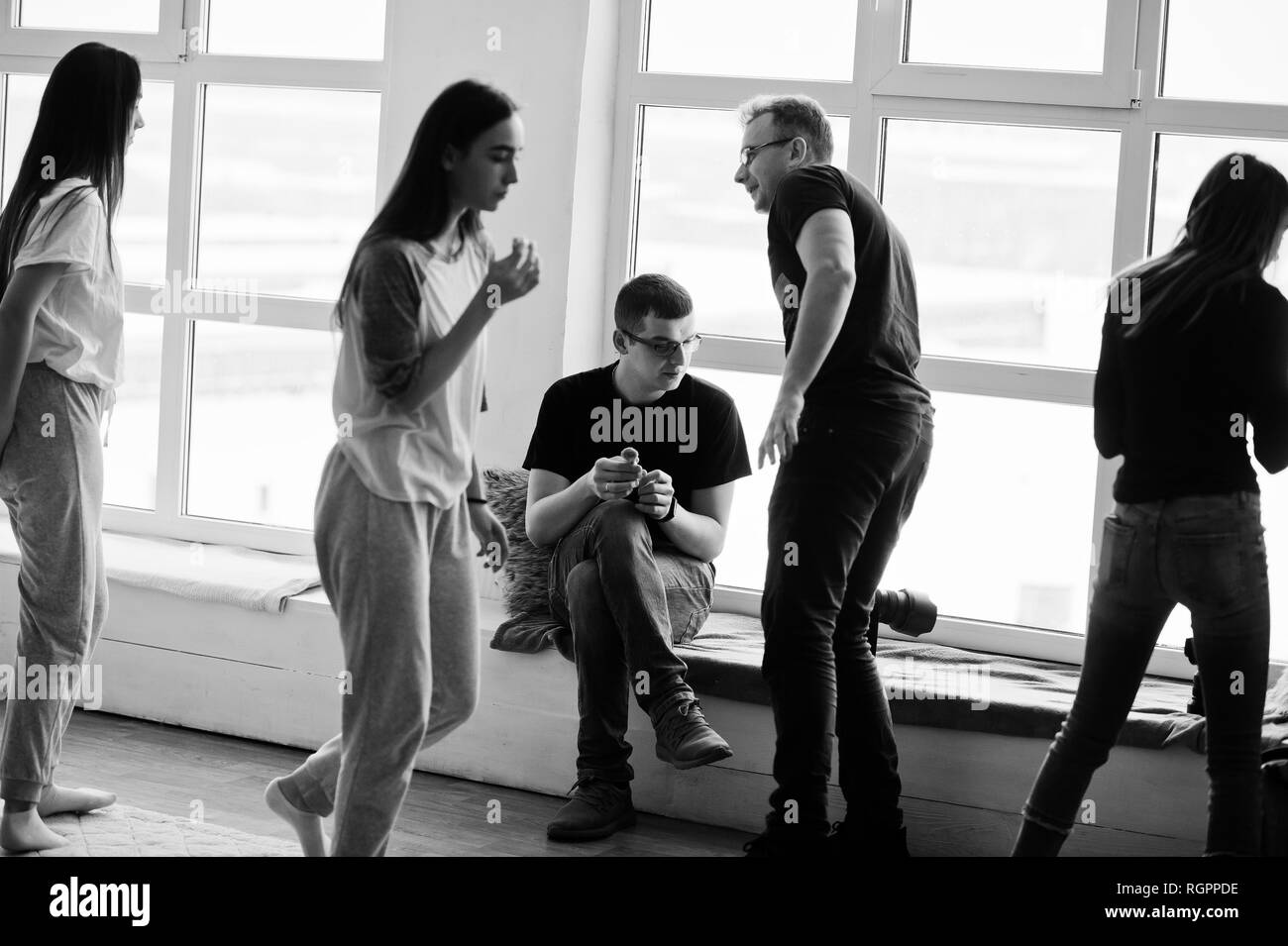 The team of photographers with twins girls at studio. Professional ...