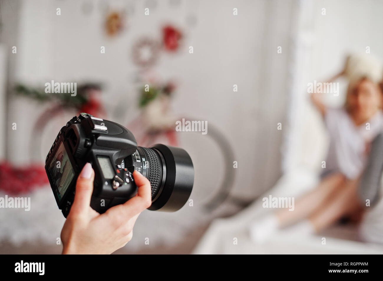 Photographer shooting hands close up with dslr camera and model posing ...