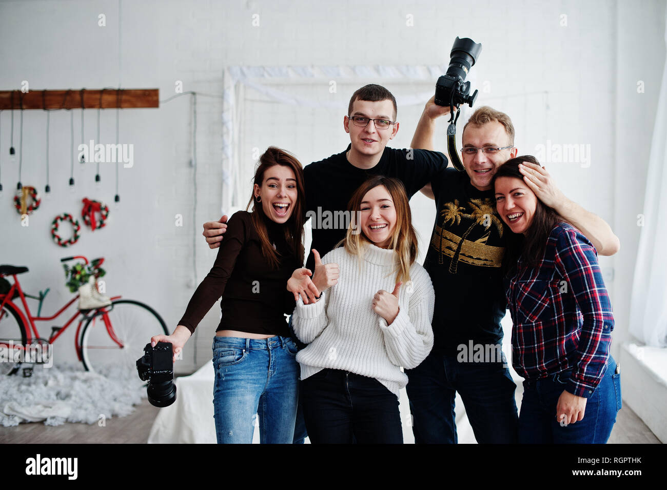 Group of five peoples, friends photographers and designers on studio ...