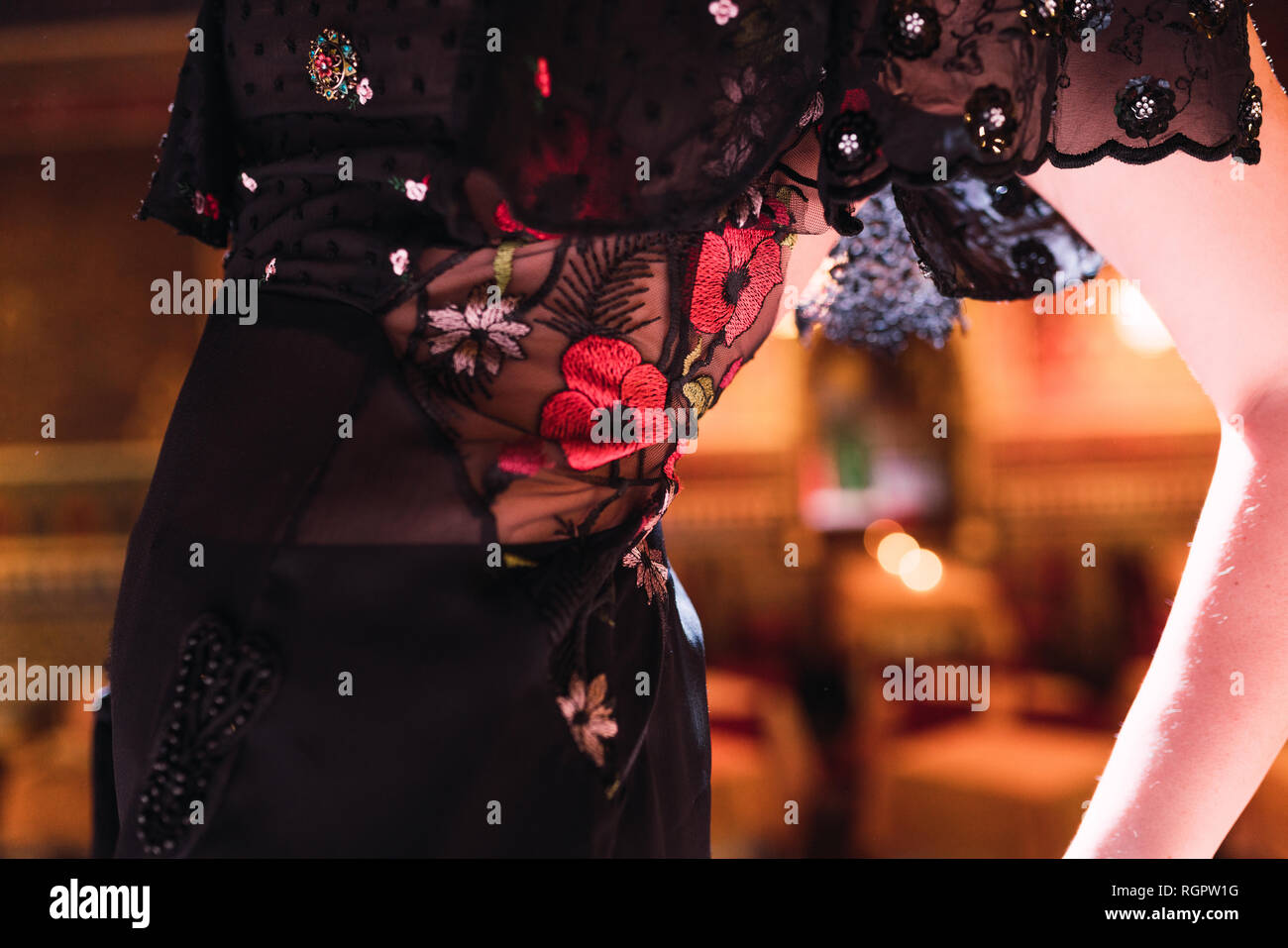 Side view crop slim lady in dress dancing on scene in room of ...