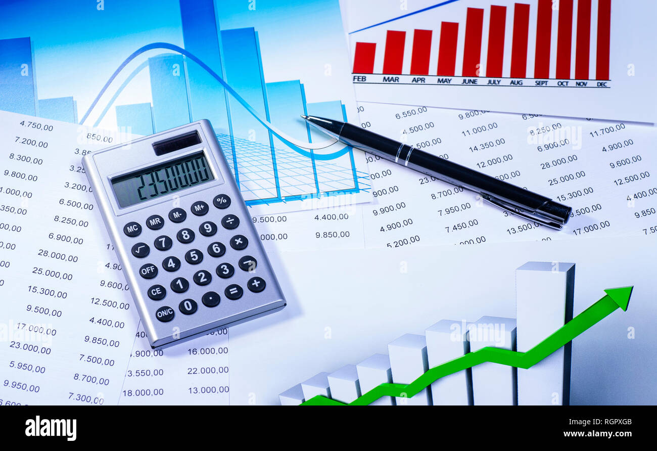 Charts and tables with calculator and pen Stock Photo - Alamy