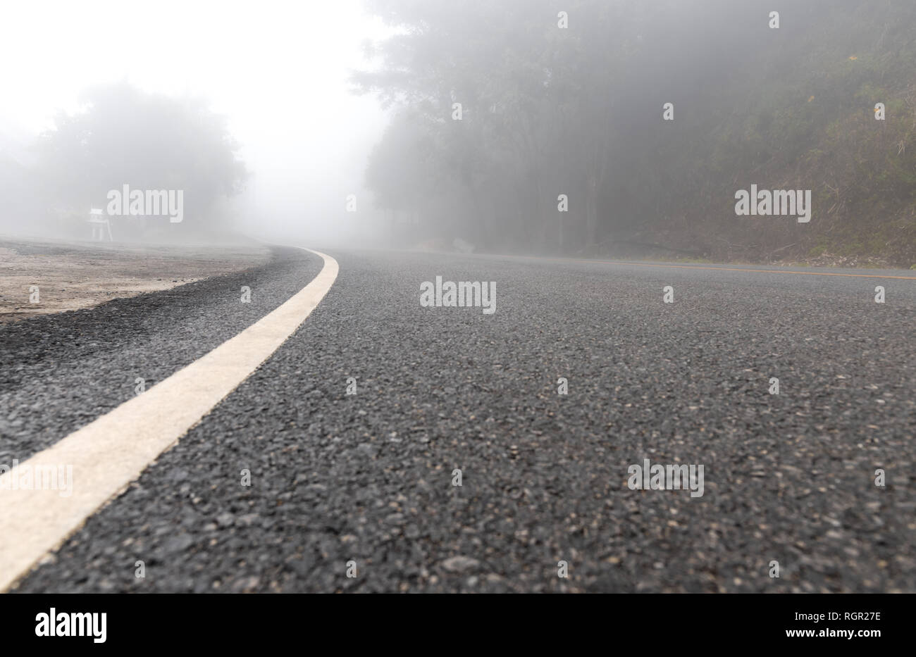 A crooked road turn into mist. Full of mysterious and dangerous ...