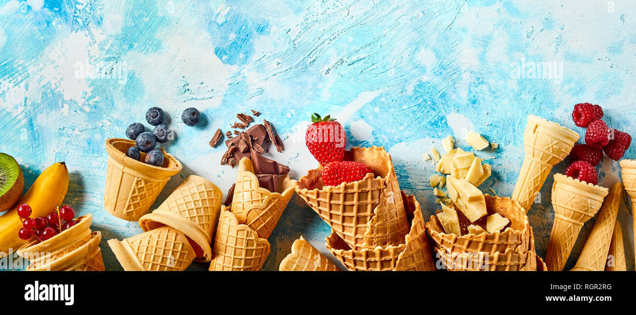 Crunchy wafer cones filled with fruits against blue background Stock ...