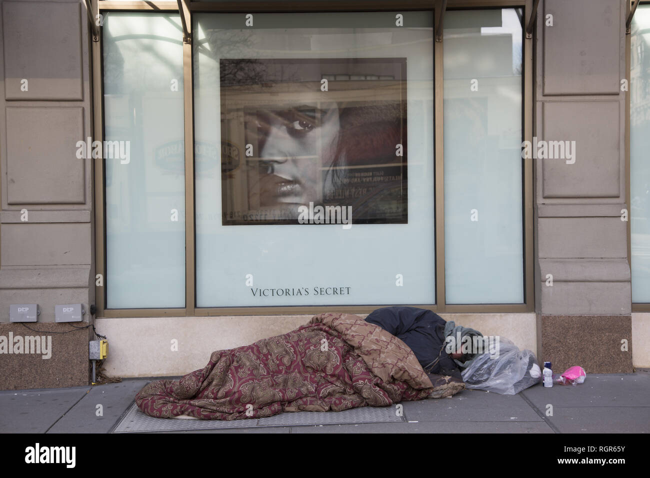 Homeless man sleeps along Broadway in front of Victoria's Secret store ...