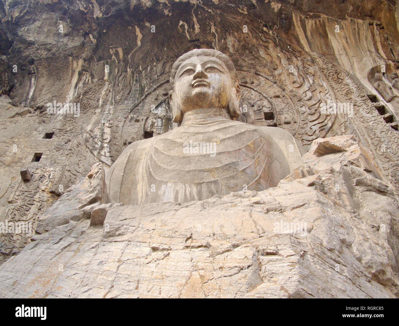 Luoyang Longmen grottoes. Broken Buddha and the stone caves and ...