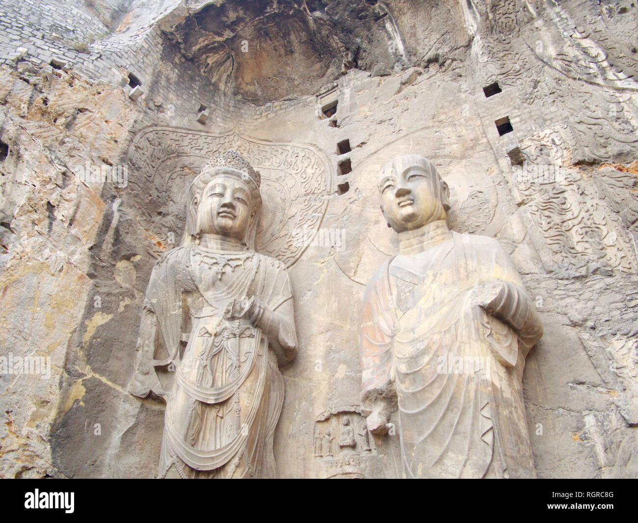 Luoyang Longmen grottoes. Broken Buddha and the stone caves and ...