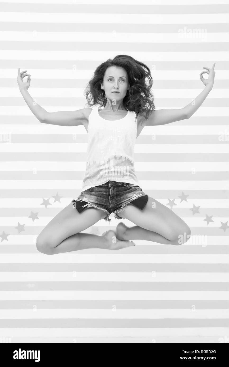 Woman fit slim lady posing as meditating while jump mid air. Healthy ...