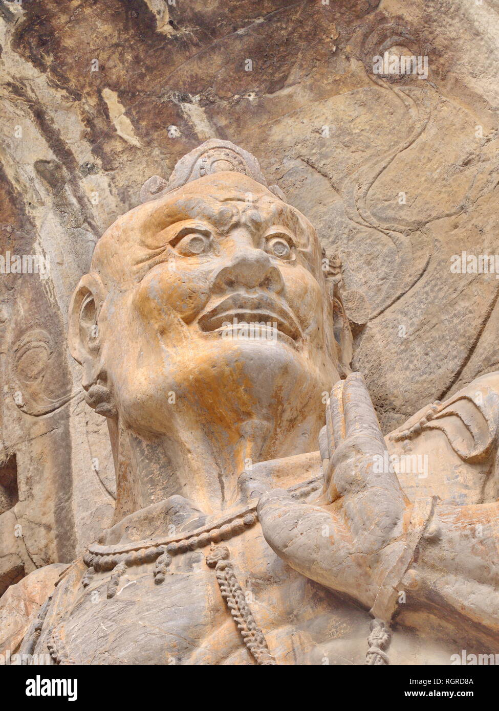 Luoyang Longmen grottoes. Broken Buddha and the stone caves and ...