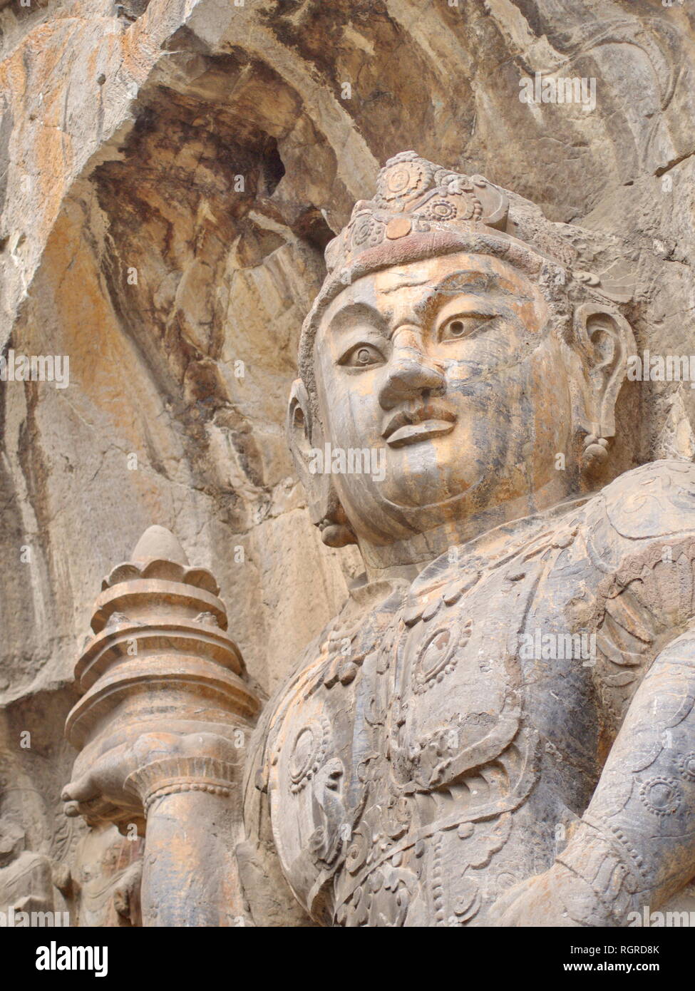 Luoyang Longmen grottoes. Broken Buddha and the stone caves and ...