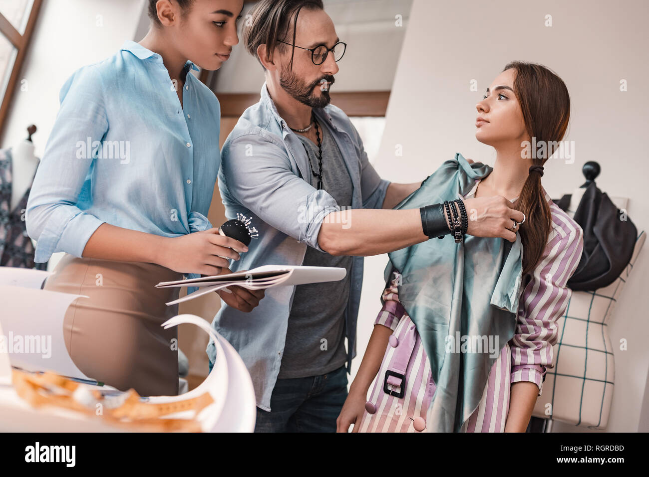 Taking measures and chooseing material. Group of three people at design ...