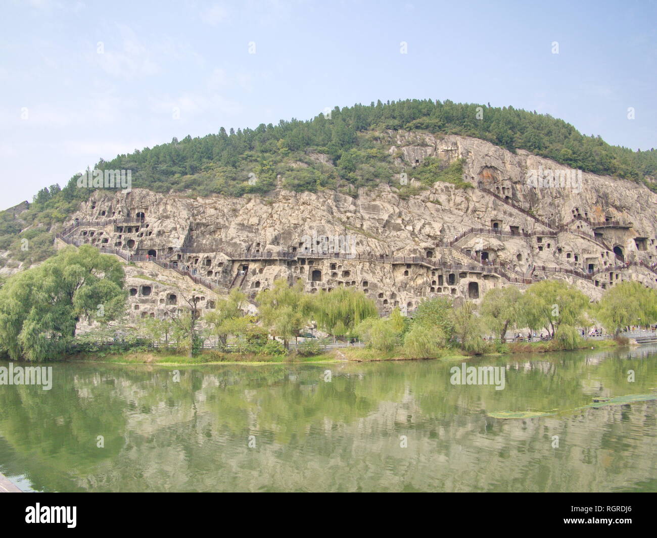 Luoyang Longmen grottoes. Broken Buddha and the stone caves and ...