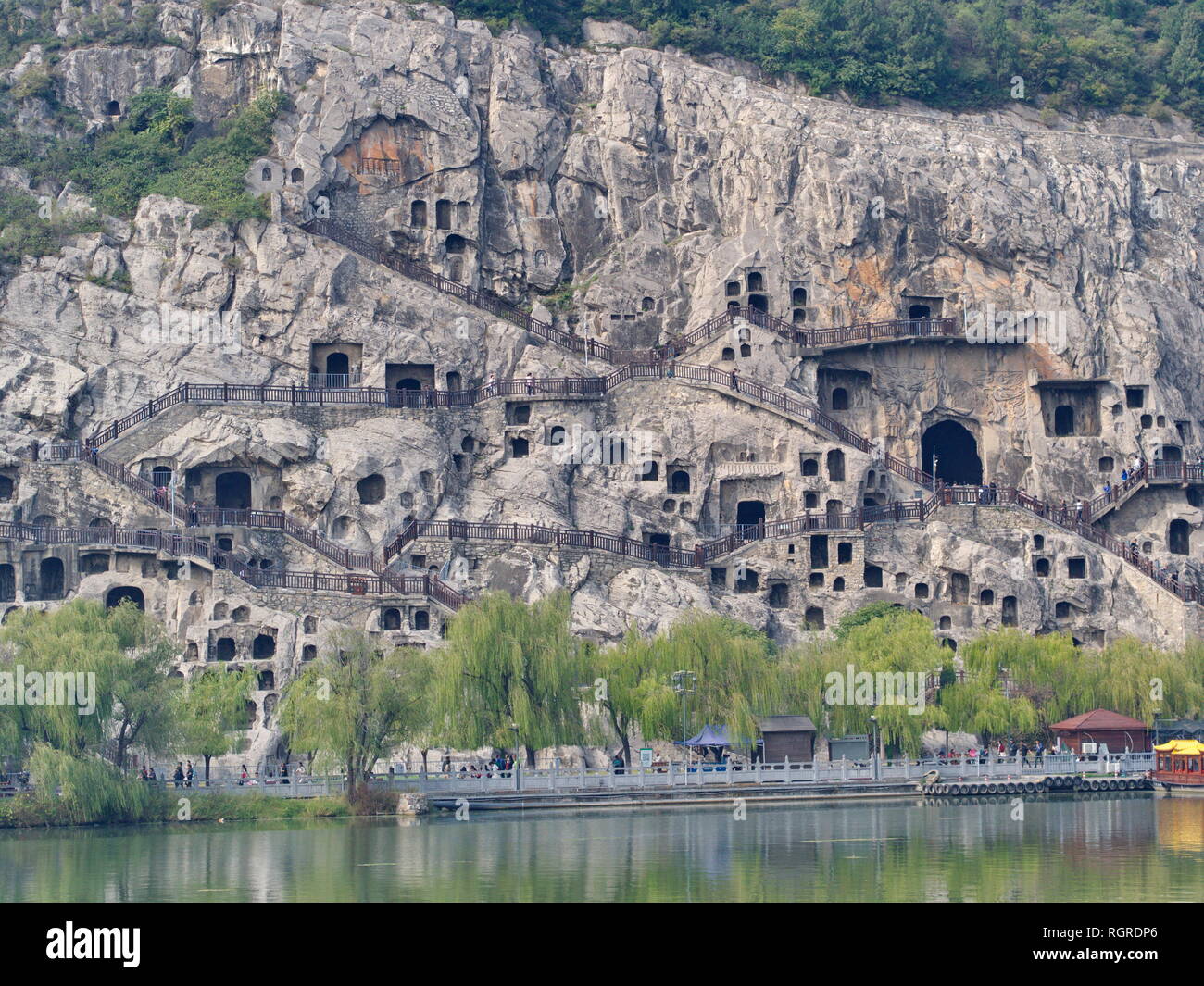 Luoyang Longmen grottoes. Broken Buddha and the stone caves and ...